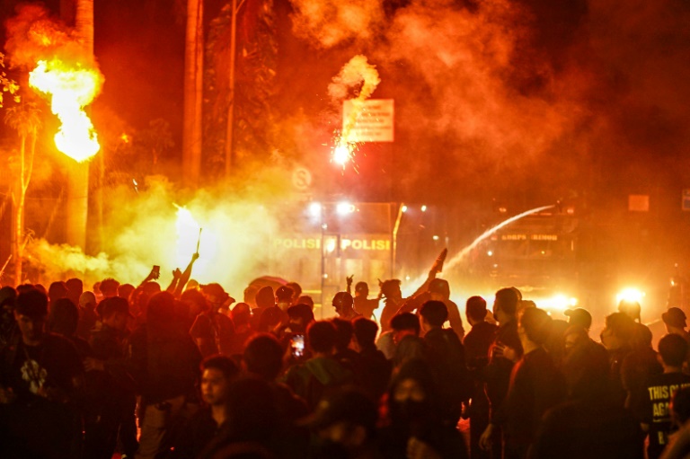 Newly passed: Water cannon break up Indonesia military law protests ...