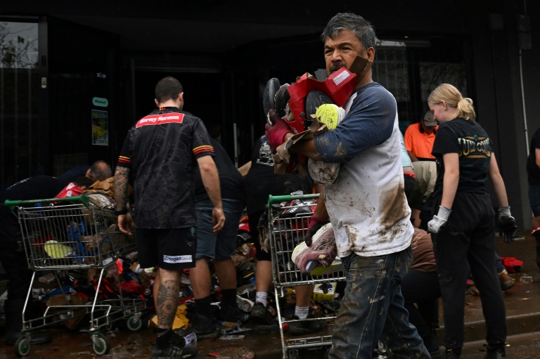 Caking houses in silt: Flood victims confront damage after record ...